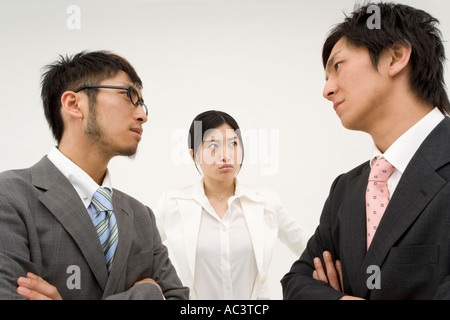 Three young men glaring at each other Stock Photo - Alamy
