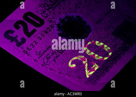 Banknote under ultraviolet light showing security features invisible in ...