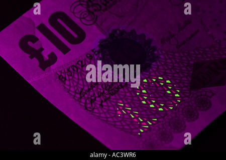 A £20 pound note under ultra violet light showing the security Stock ...