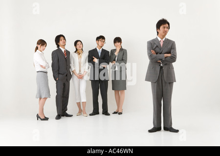Businessman excluded from group of business people Stock Photo - Alamy