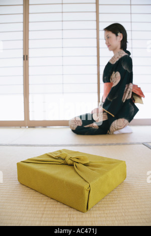 Woman sitting on the floor in a relaxed position Stock Photo - Alamy