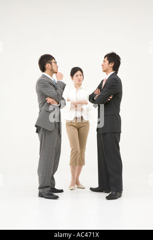 Three business people glaring at each other Stock Photo - Alamy
