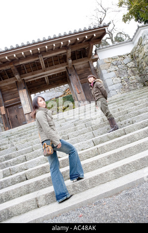 Young woman standing in temple gates at Lempuyang Luhur temple in Bali ...