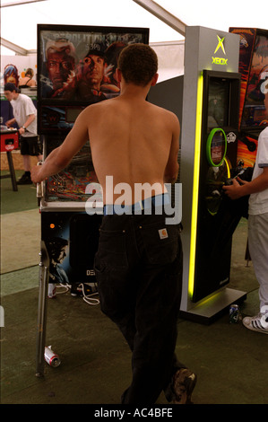 A young man playing on the pinball machine at the urban games on ...