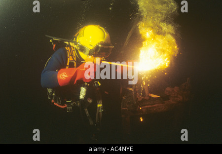 Commercial diver working underwater welding with an oxygen lance Stock ...