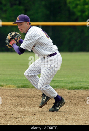 High school shortstop throwing to first base to retire an opposing ...