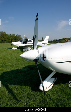 Light aircraft on airfield, door open, showing cockpit Stock Photo - Alamy