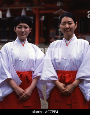 At the Ikuta Shinto Shrine in Kobe, a young Miko, shrine maiden, bows ...