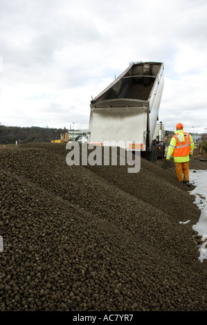 Tipper lorry unloading aggregate Stock Photo - Alamy