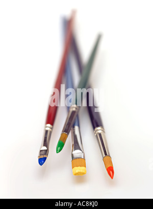 A vertical shot of artists' paint brushes in pots seen through a shop ...