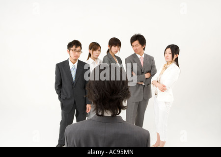 Businessman excluded from group of business people Stock Photo - Alamy