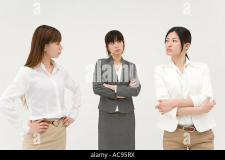 Three business people glaring at each other Stock Photo - Alamy