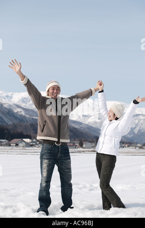 Young adult couple in the arms of each other on the snow-covered tram ...