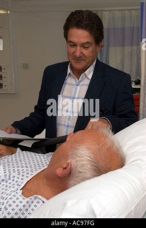 Patient being overseen by GP in recovery room following operation at a ...