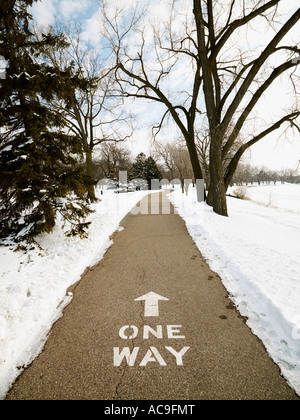 Paved path in park reading one way Stock Photo - Alamy