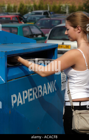 Young Woman Putting Paper Into Paperbank Stock Photo - Alamy