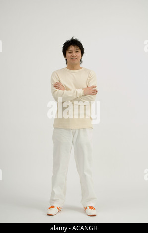 Portrait of smiling young man with full shopping cart in fruit market ...