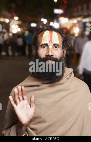 Portrait of a sadhu standing on one leg on the support of swing at Maha ...