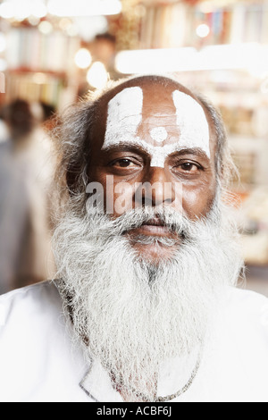 Portrait of a sadhu standing on one leg on the support of swing at Maha ...
