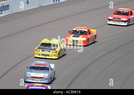 Racing pick up trucks racing around a banked circuit Stock Photo - Alamy