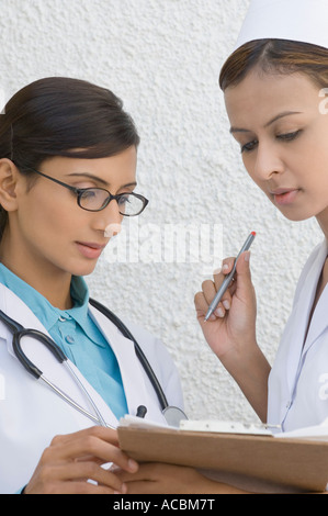 Asian women doctor holding clipboard medical record smiling ...