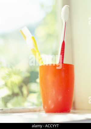 Vertical image of toothbrushes in cup on grey background Stock Photo ...