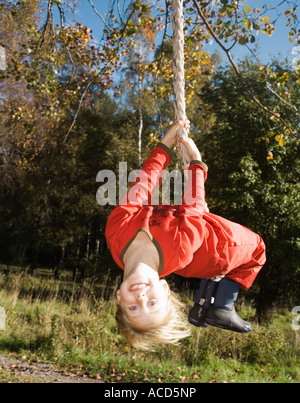 children girl swinging in a tree trunk in a pine forest Stock Photo - Alamy