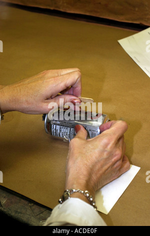 Fingerprint expert lifting print off aluminum can using lift tape ...