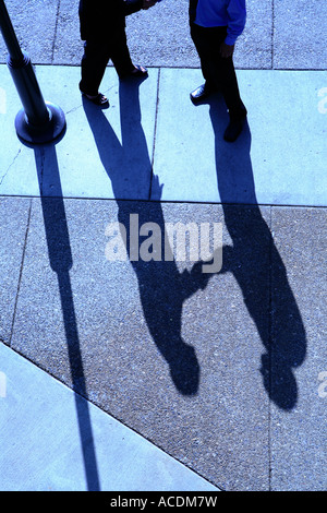 Businesspeople shaking hands with shadows on ground Stock Photo - Alamy