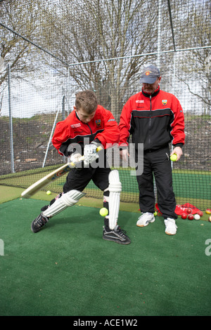 junior cricket player practicing with his trainer Stock Photo - Alamy