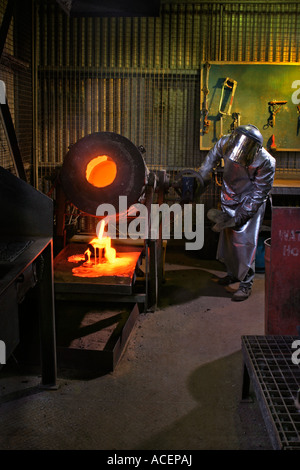 Pouring molten gold into 28 kg ingot from tilting ore furnace Stock ...