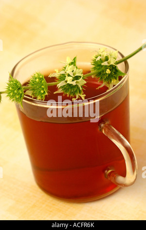 Flowers in an iron mug on the wooden background. Toned image Stock ...
