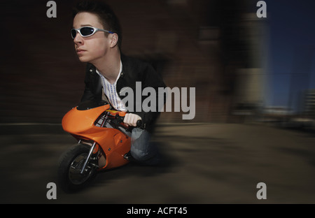 man riding mini motorcycle Stock Photo - Alamy