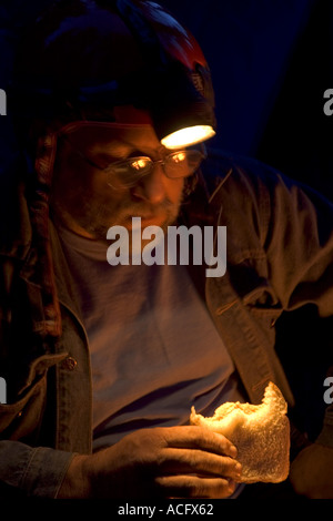Hungry man eating. Sandwich outdoors. hiker eating sandwich sitting in ...