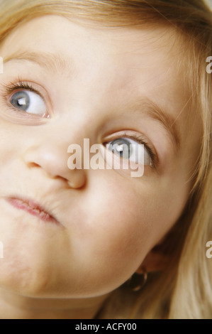 Little girl, silly and goofy face on green screen with facial expressions against a studio ...