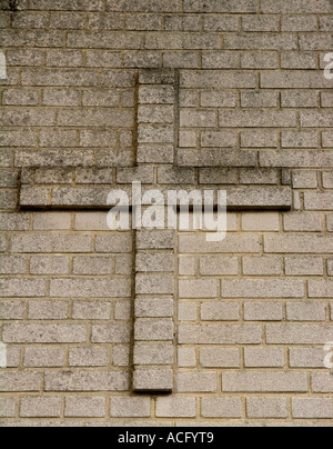 Brick wall with embedded stone and cross motif. Historic and minimal ...