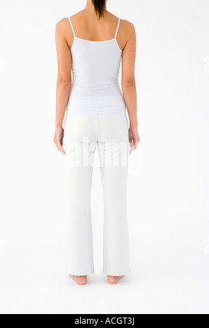 A young fitness woman is standing on a rock in the river Stock Photo ...