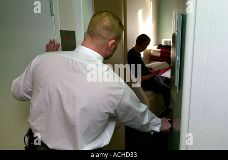 Prison officer locking a cell door Stock Photo - Alamy