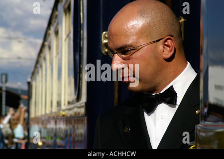 Orient Express luxury train and uniformed steward happy smiling ...