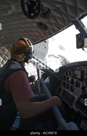 Pilot in cockpit of bush plane, float plane de Havilland Canada DHC-3 ...