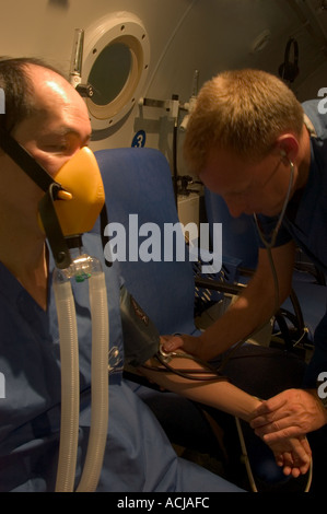Patient undergoes hyperbaric oxygen treatment in recompression chamber ...