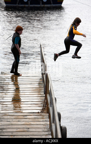 Boys jumping off Jetty into sea, Brighton, English Seaside Town ...