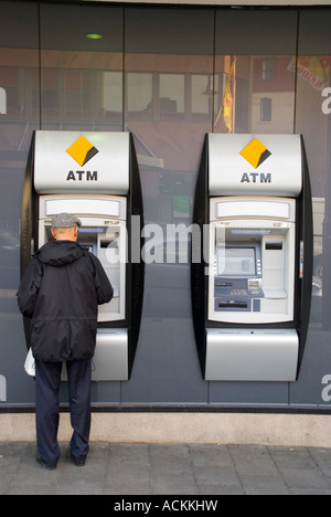 Man using an Australian Commonwealth Bank automatic teller machine ...