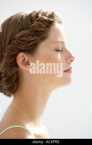 side view of beautiful young woman and smiling makeup artist taking ...