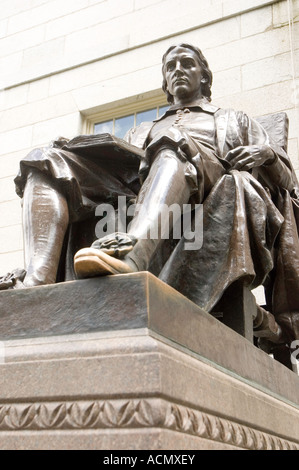 Student at the John Harvard statue by Daniel Chester French, the touch ...