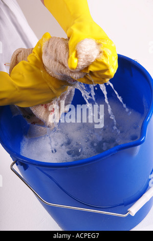 cropped view of woman cleaning out ripe pumpkin near fresh cucumbers ...