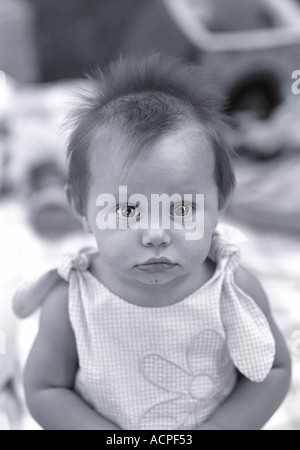 small baby girl or cute child with happy face in red chef hat and cook ...