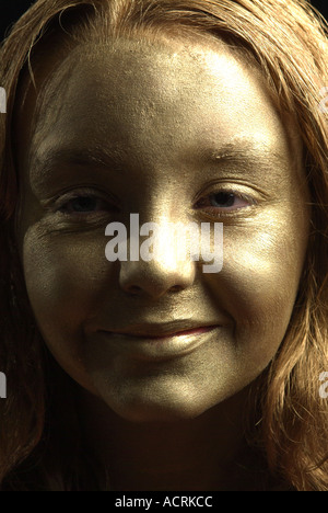 gold face girl with half face shadowed eyes closed no smile sad Stock ...