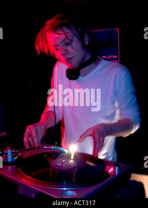 Young DJ playing on turntables with color light effects Stock Photo - Alamy