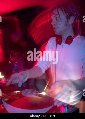 Young DJ playing on turntables with color light effects Stock Photo - Alamy